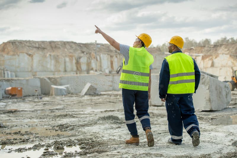 Two Male Workers Discussing Features of Construction Site Stock Photo ...
