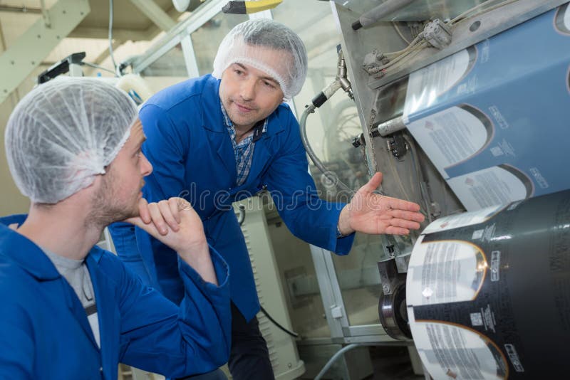 Two Male Workers by Industrial Printing Machines Stock Image - Image of ...