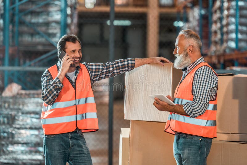 Two Male Workers Using Digital Devices while Working Stock Image ...
