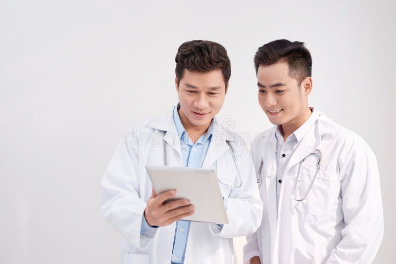 Two Man Doctor Looking at the Ipad/tablet and Having a Discussion Stock ...