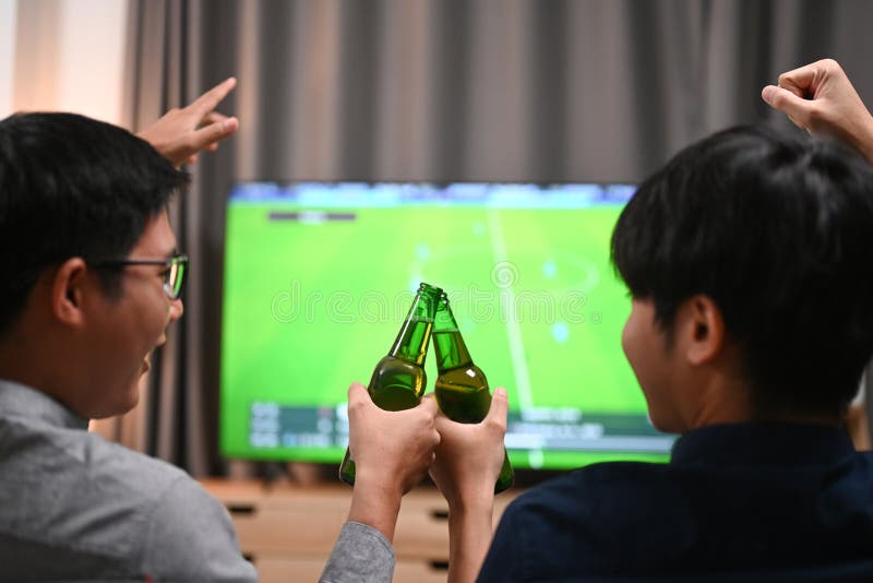 Two Man Drinking Beer and Watching Football Match at Home. Stock Photo ...