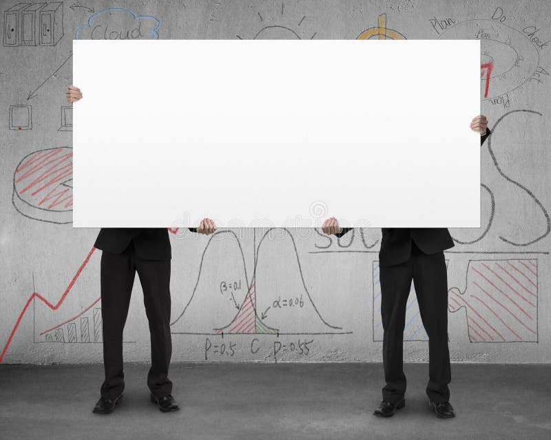 Two Man Holding Board with Business Doodles on Wall Stock Photo - Image ...