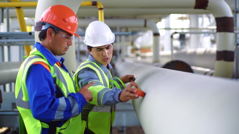 Two Man Industrial Builder Engineer in Uniform Measuring Pipe Size for ...
