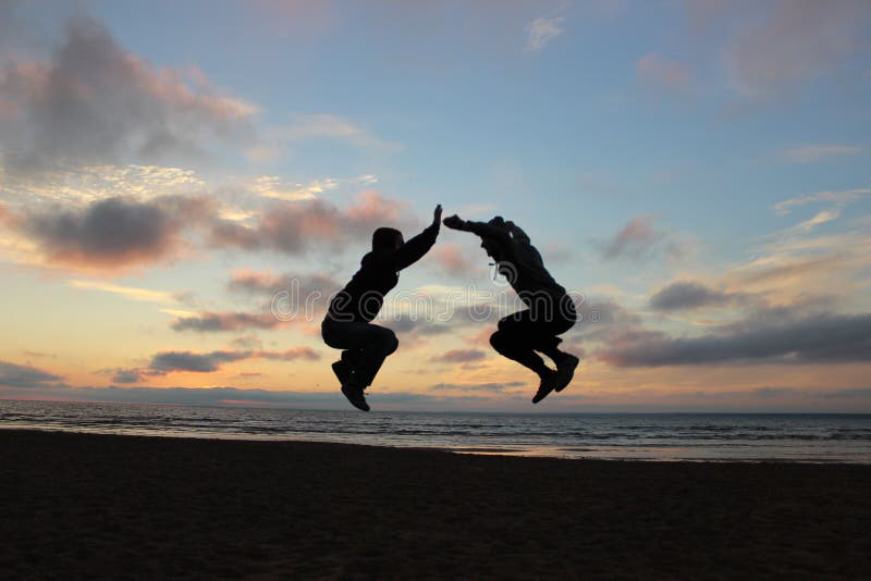 Two Man Jump Hight in Front of Sea Sunset Stock Image - Image of open ...
