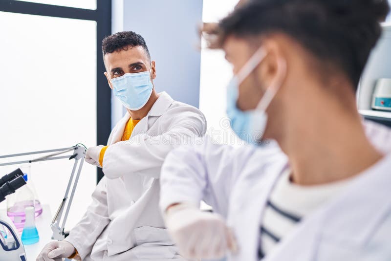 Two Man Scientists Doing Elbow Greeting at Laboratory Stock Image ...