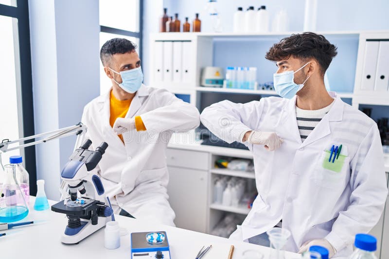 Two Man Scientists Doing Elbow Greeting at Laboratory Stock Photo ...