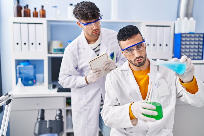 Two Man Scientists Measuring Liquid at Laboratory Stock Photo - Image ...