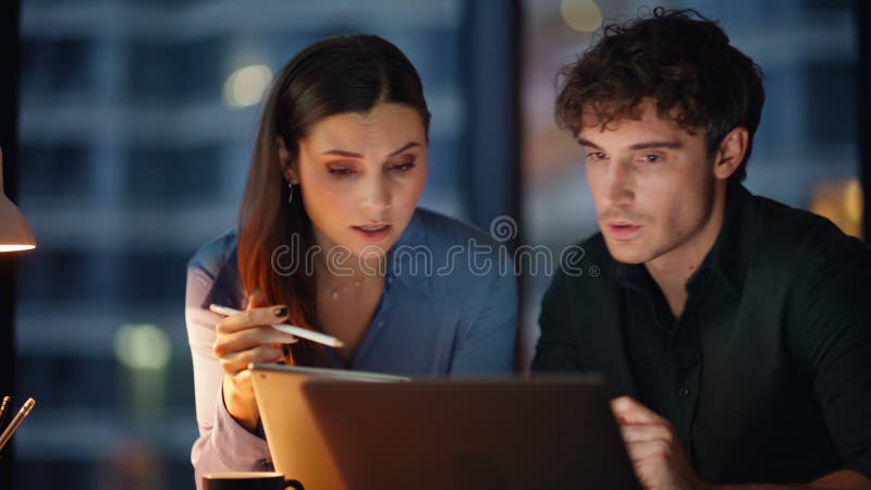 Two Managers Analyzing Project Looking Tablet Data at Dark Office ...