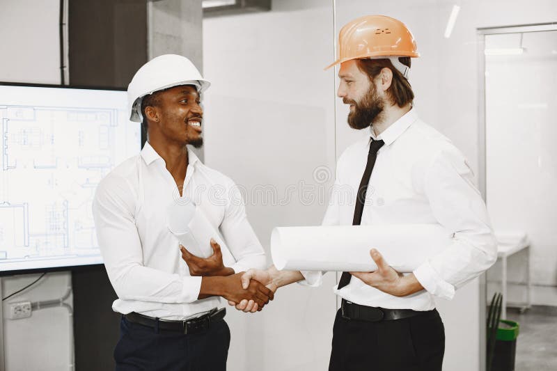 Two Managers in the Office with Helmets Stock Photo - Image of african ...