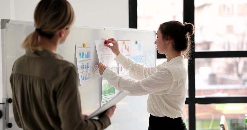 Two Managers are Preparing a Business Presentation with Reports on ...