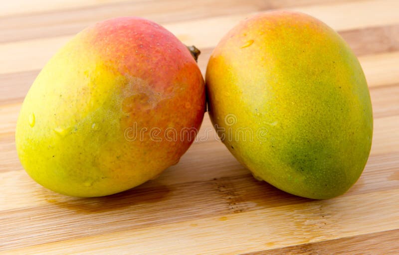 Two mango on carving board stock image. Image of healthy - 48989161