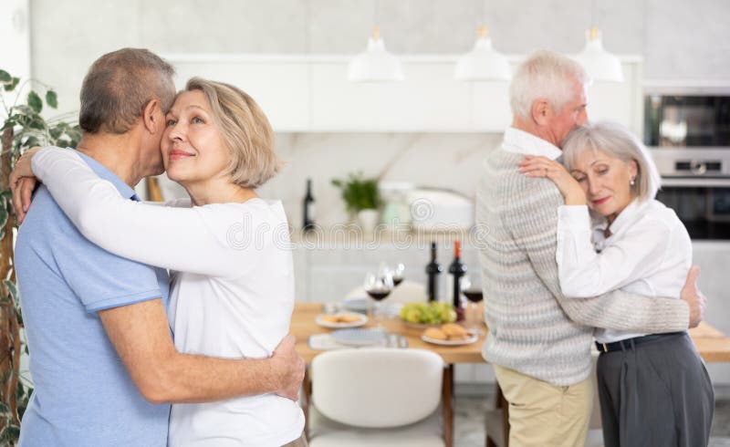Two Married Couples Enjoying Slow Dancing at House Party for Friends ...