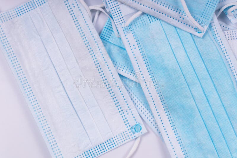 Two Masks on Top of the Others Lie Parallel, One White Side Up and the ...