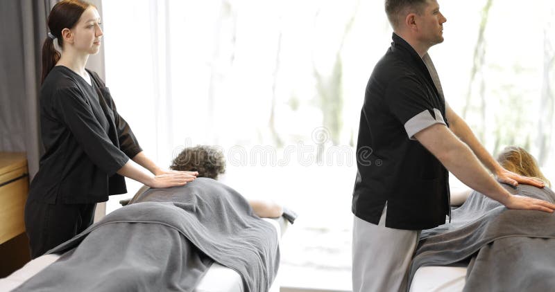 Two Masseurs Doing A Massage For A Couple At Spa Stock Footage Video