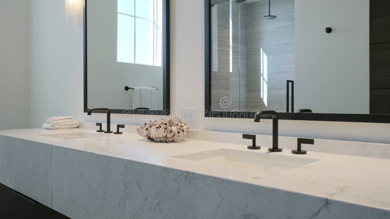 Two Massive White Marble Sinks Equipped with Matte Black Sanitary Ware ...