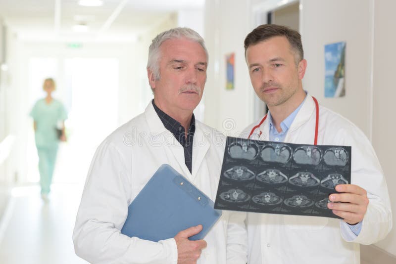 Two Mature Male Radiologist Holding X-ray Stock Image - Image of mature ...