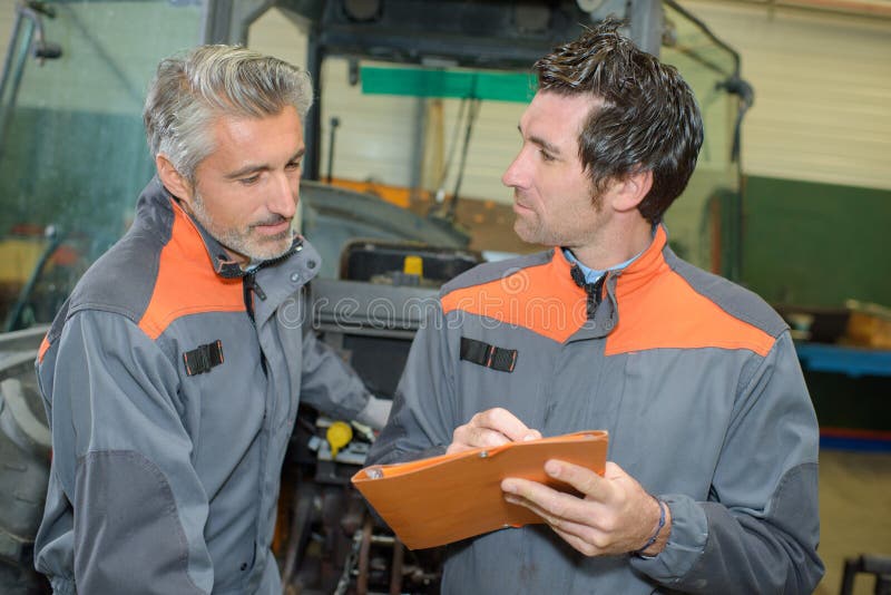 Two Mature Mechanics in Discussion Stock Image - Image of worker ...