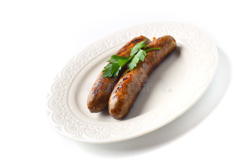 Two Meat Sausages with Parsley on the Plate on a White Background Stock ...