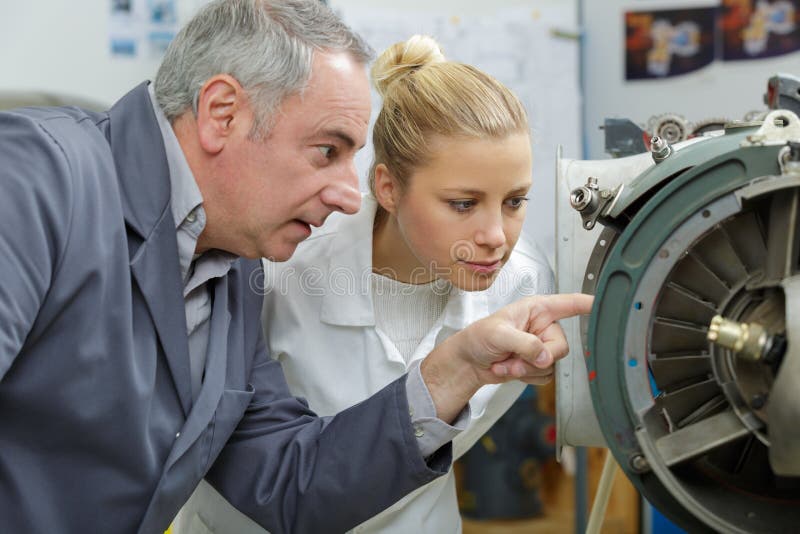 Two Mechanic Engineers Examining Wheel Stock Photo - Image of girl ...