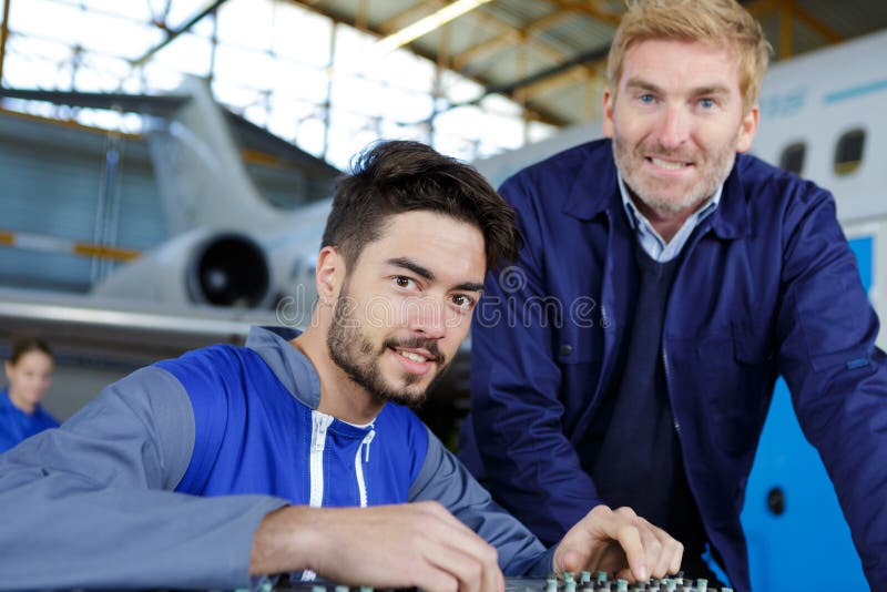 Two mechanics in hangar stock image. Image of cooperation - 268034759