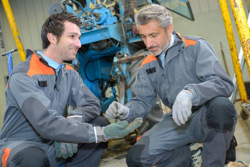 Two mechanics having pause stock photo. Image of play - 245861362