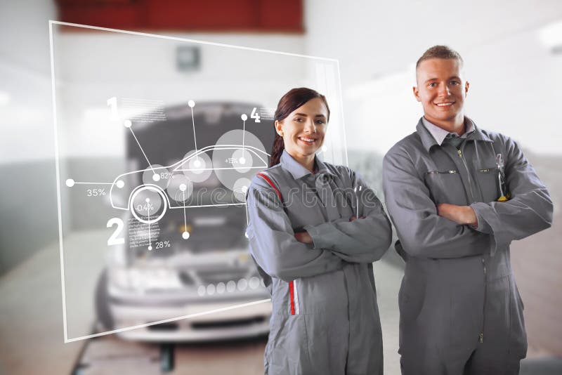 Mechanic Holding a Digital Tablet Against Digital Interface in Workshop ...