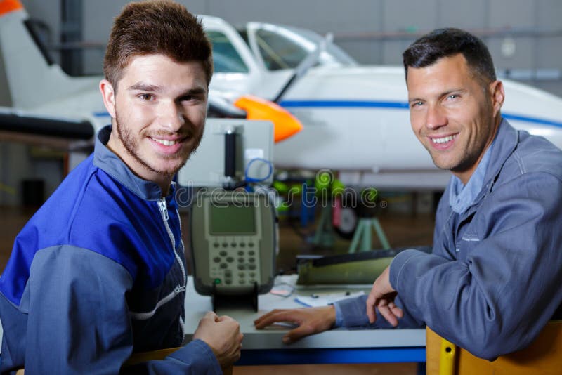 Two Mechanics Working on Aircraft Stock Photo - Image of plane ...
