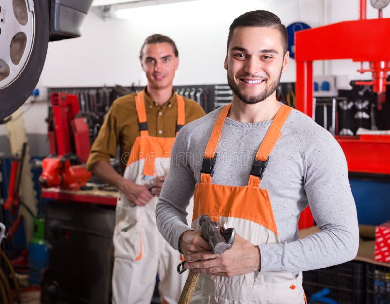 Two mechanics in workshop stock image. Image of adults - 61430409