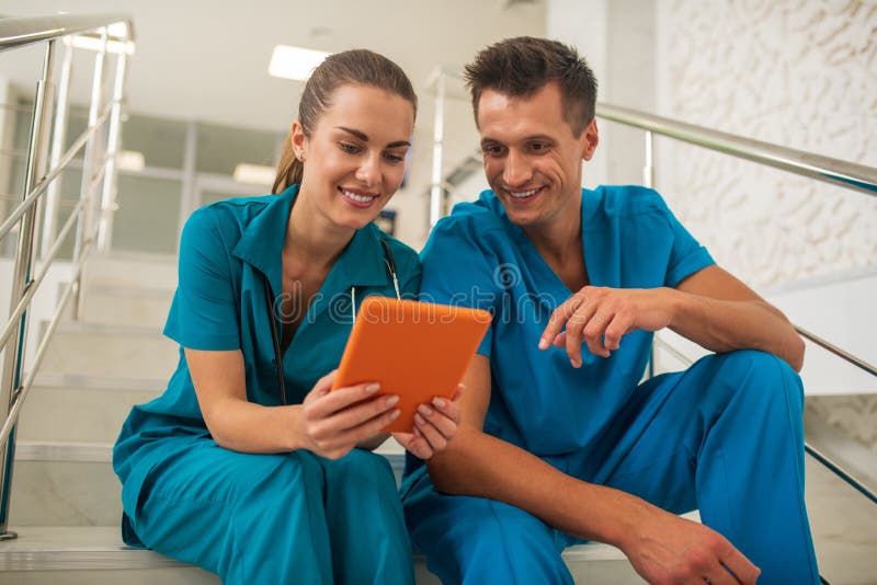 Two Medical Workers Watching Something on Internet and Discussing Stock ...