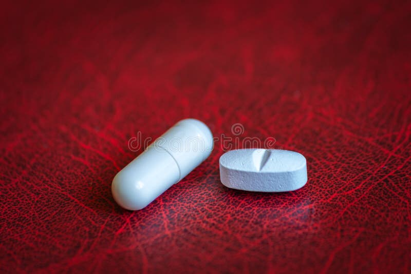 Two Medicine White Pills Lies on the Table in Close-up Stock Photo ...