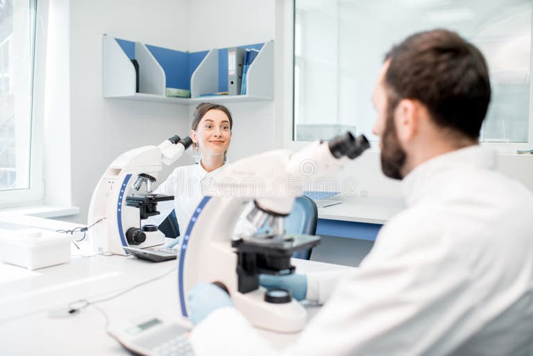 Medics Working with Microscope at the Laboratory Stock Image - Image of ...