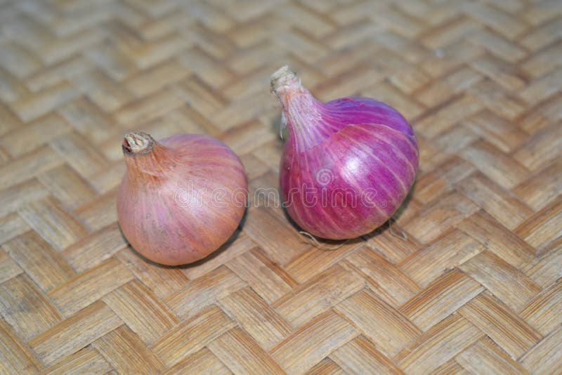 Two Medium Pieces of Fresh Red Onion Placed Over a Wood Colored ...
