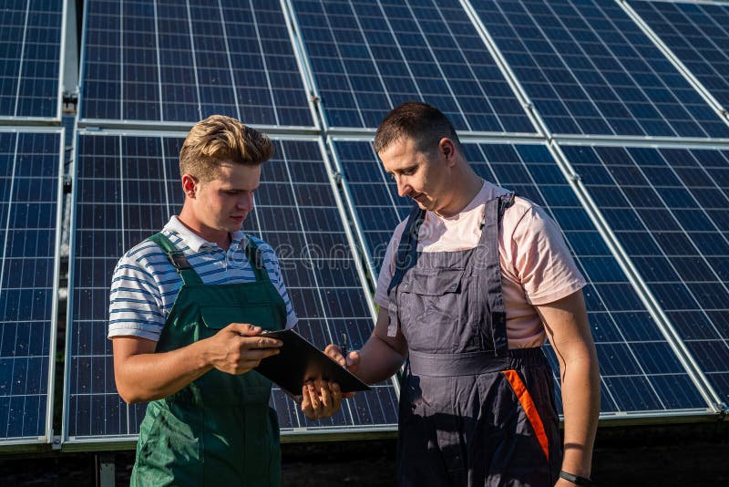 Two Men Against Solar Panels Making Agreement about Installation of ...