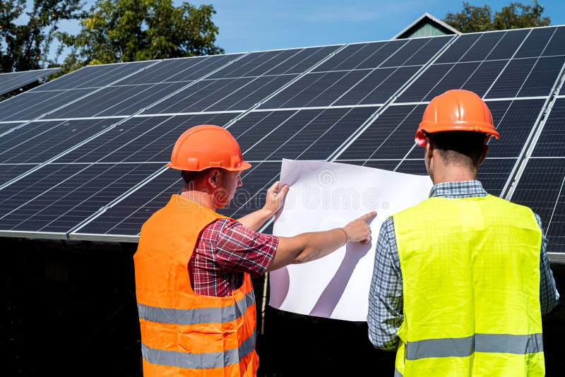 Two Men Against Solar Panels Making Agreement about Installation of ...