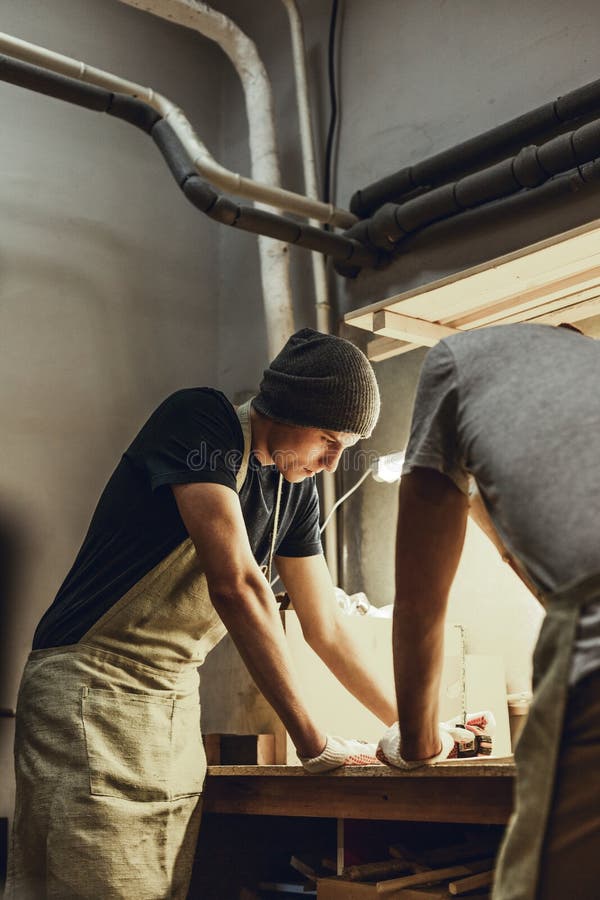 Two Craftsmen Standing Near Workbench Stock Photo - Image of together ...