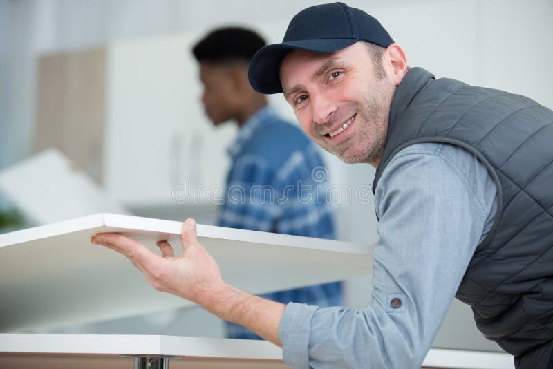 Two Men Assembling Kitchen Cupboard Stock Photo - Image of board ...