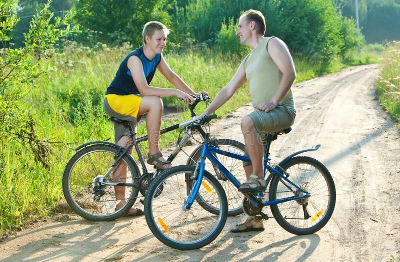 Two men on bicycles stock image. Image of enjoying, action - 20505361