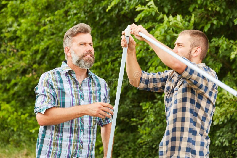 Two Men Build a Tent Together Stock Photo - Image of social, summer ...