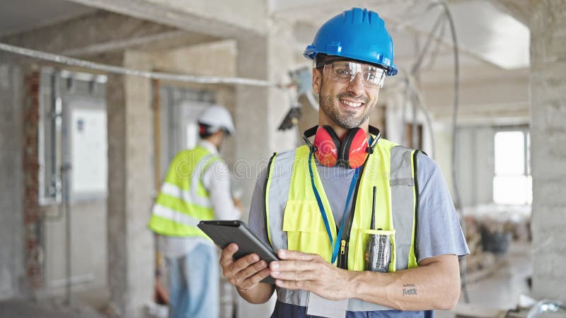 Two Men Builders Smiling Confident Using Touchpad at Construction Site ...
