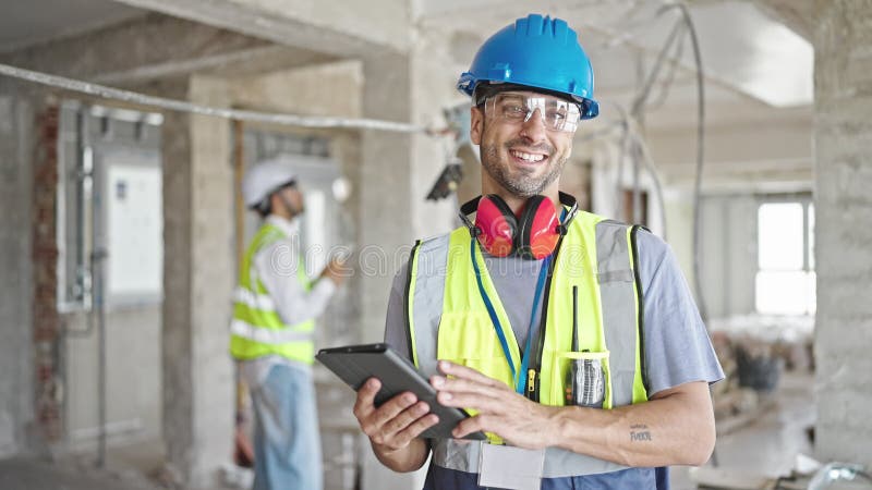 Two Men Builders Smiling Confident Using Touchpad at Construction Site ...