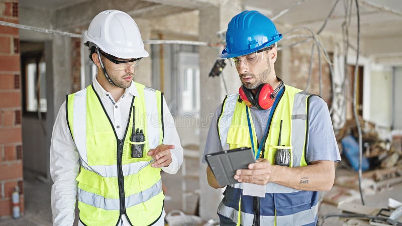 Two Men Builders Using Touchpad at Construction Site Stock Photo ...