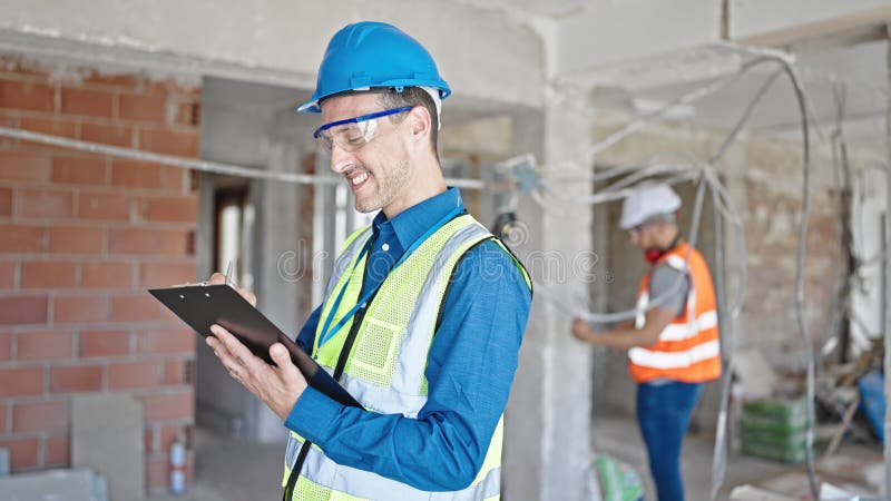 Two Men Builders Writing Document Working at Construction Site Stock ...