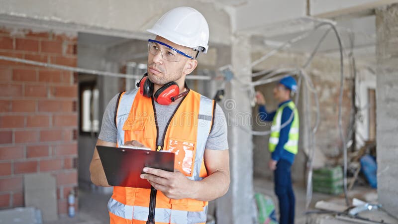 Two Men Builders Writing Document Working at Construction Site Stock ...
