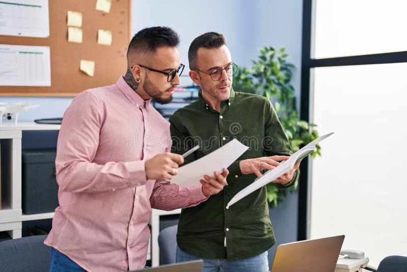 Two Men Business Workers Reading Document and Notebook at Office Stock ...