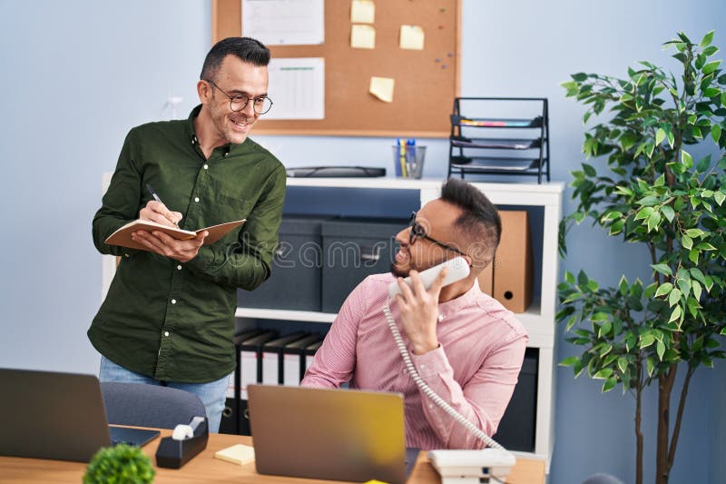 Two Men Business Workers Talking on Telephone Writing on Notebook at ...