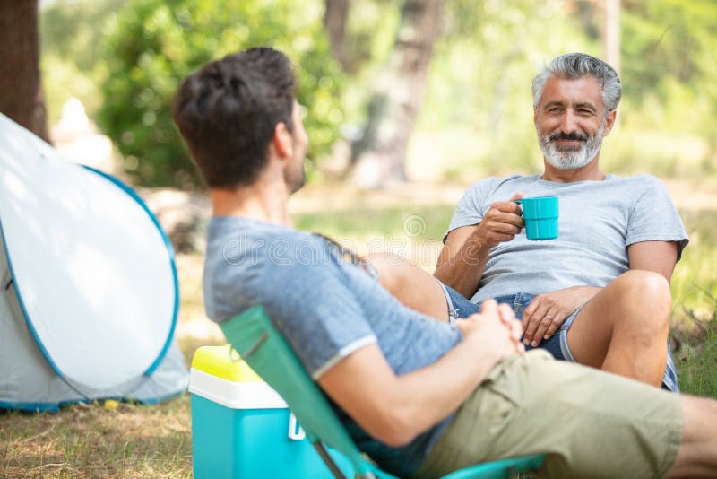 Two men on camping holiday stock image. Image of fishing - 256659185