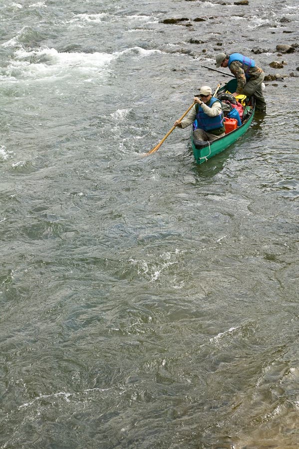Two Men in a Canoe Navigating Wild River Rapids Editorial Stock Image ...