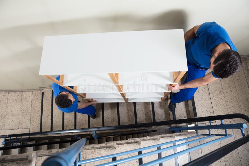 Two Men Carrying Shelf stock photo. Image of furniture - 222462788