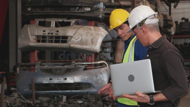 Two Men Checking Engine Parts in a Warehouse. with Both of Them Wearing ...