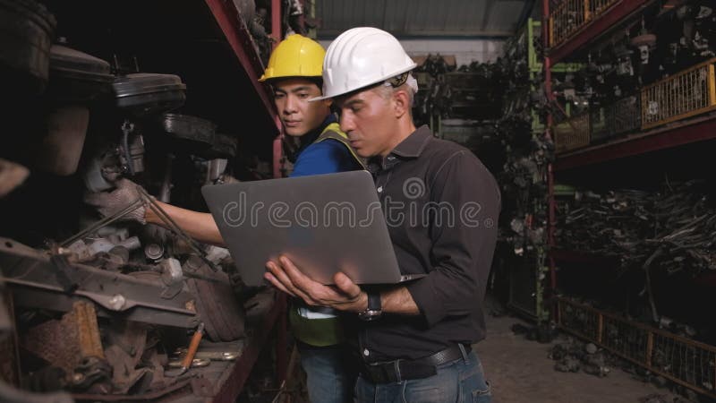 Two Men Checking Engine Parts in a Warehouse. with Both of Them Wearing ...
